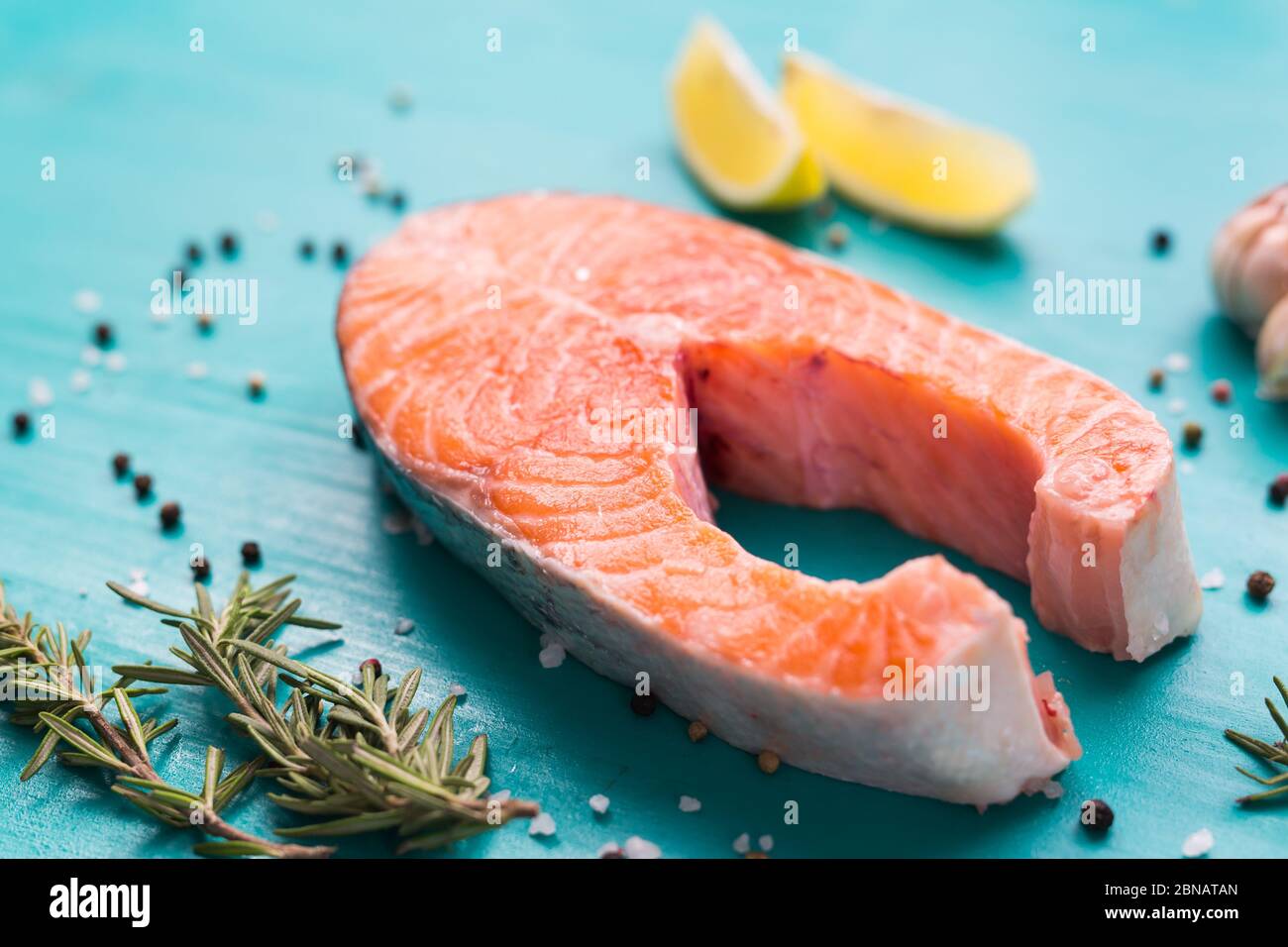Fresh salmon fillet on blue background, food close up. Diet, omega ...