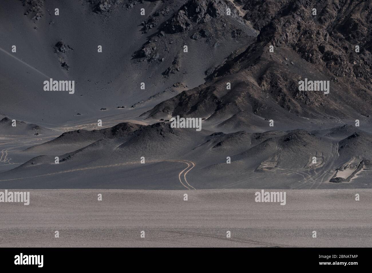 Barren mountains on rocky desert landscape and some wheel ruts Stock ...