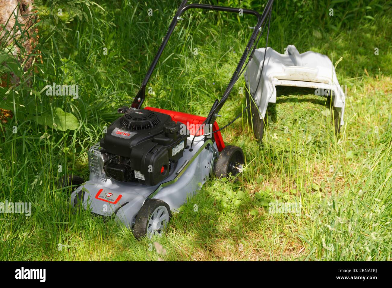Lawn mower in a garden path Stock Photo - Alamy