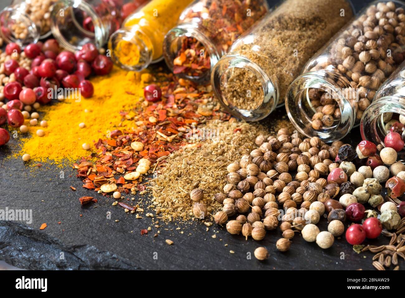 Various spices in small glass bottles Stock Photo - Alamy