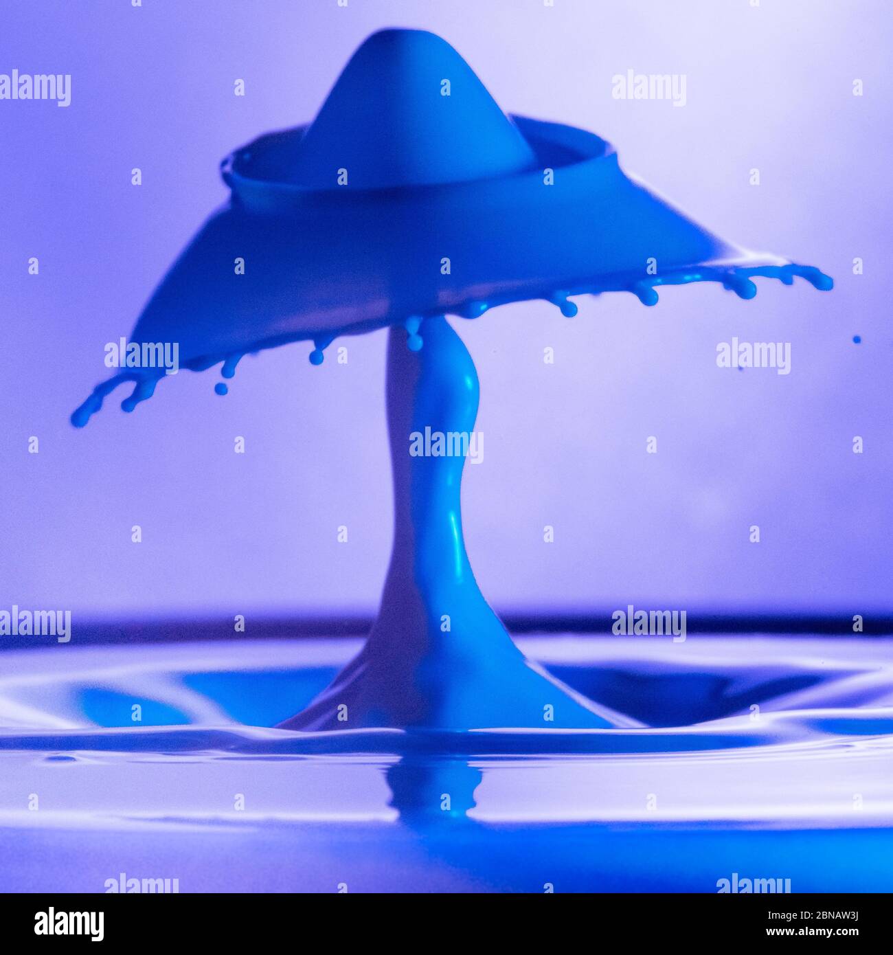 Closeup of a cool blue water splash against a blurred background ...