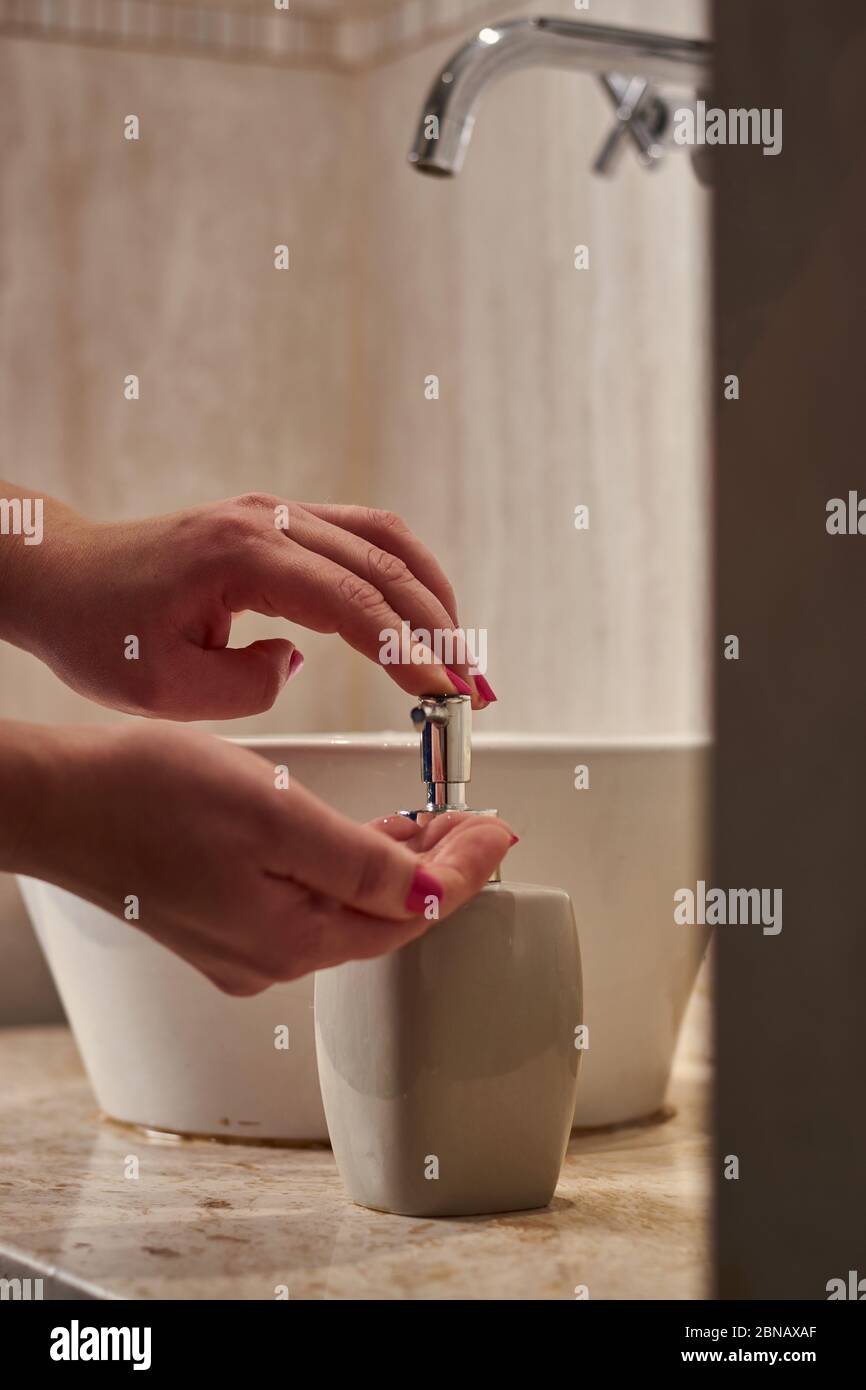 Girl using bathroom sink hi-res stock photography and images - Alamy