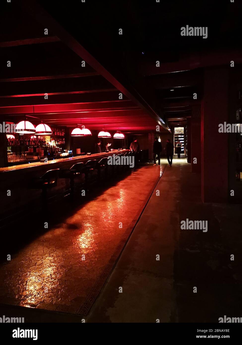 Vertical shot of a bar with red lights Stock Photo - Alamy