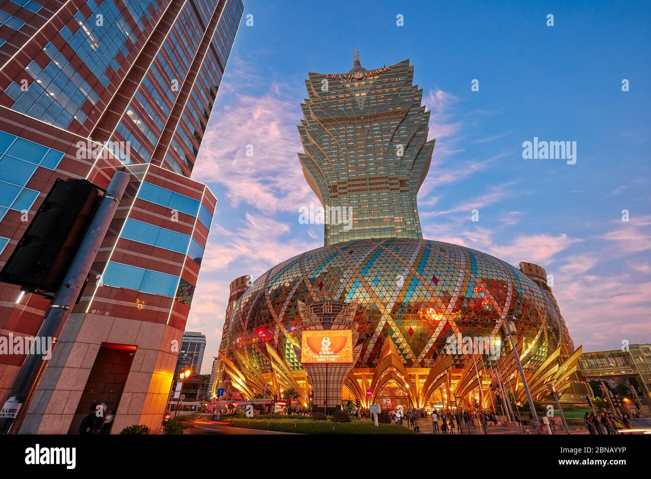 Colourful building of the Hotel Grand Lisboa illuminated at dusk. Macau ...