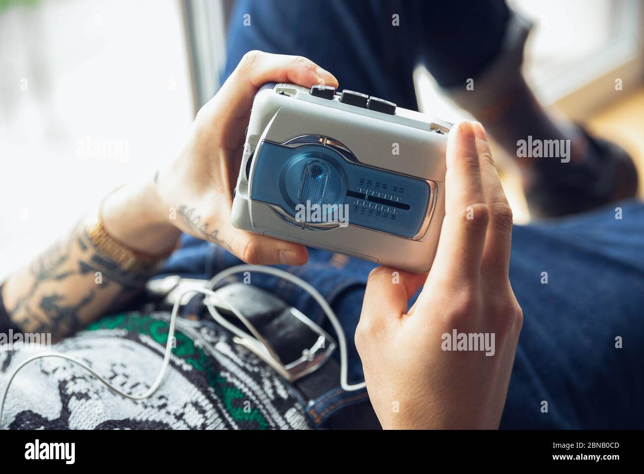 Portrait of millenial boy using retro toys, meeting things from the ...