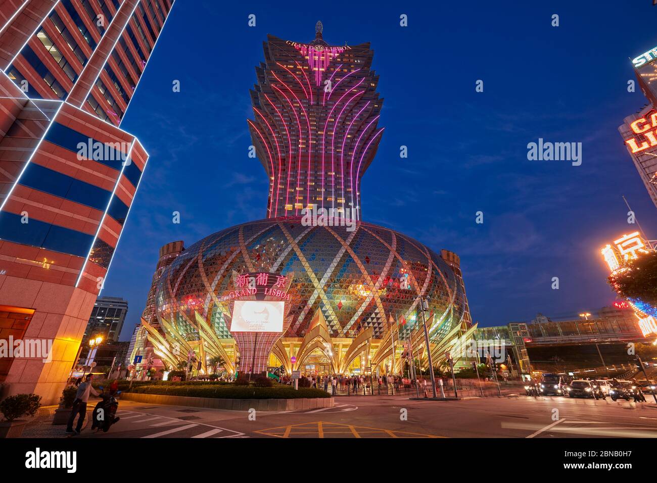 Colourful building of the Hotel Grand Lisboa illuminated at night ...