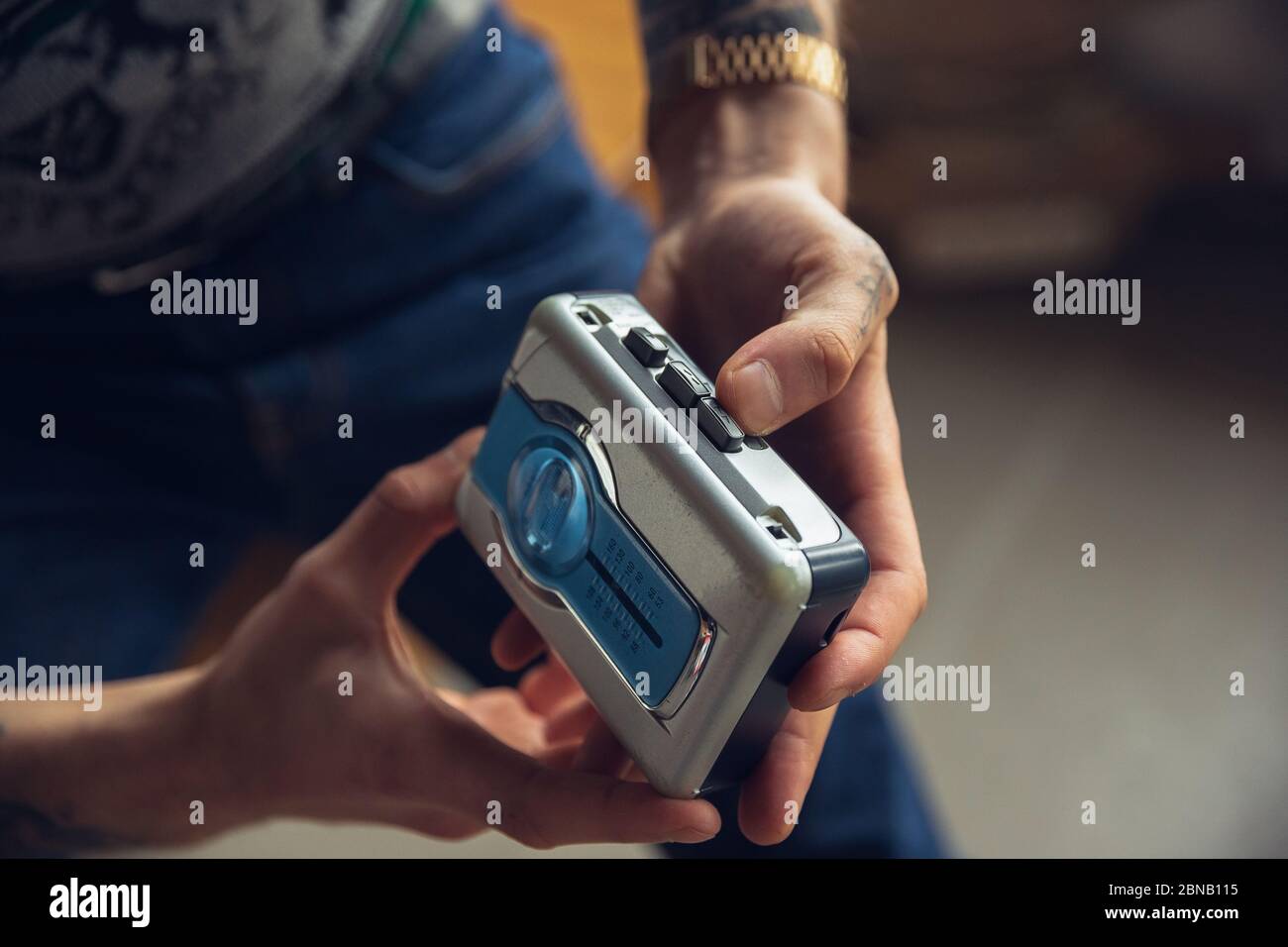 Portrait of millenial boy using retro toys, meeting things from the ...