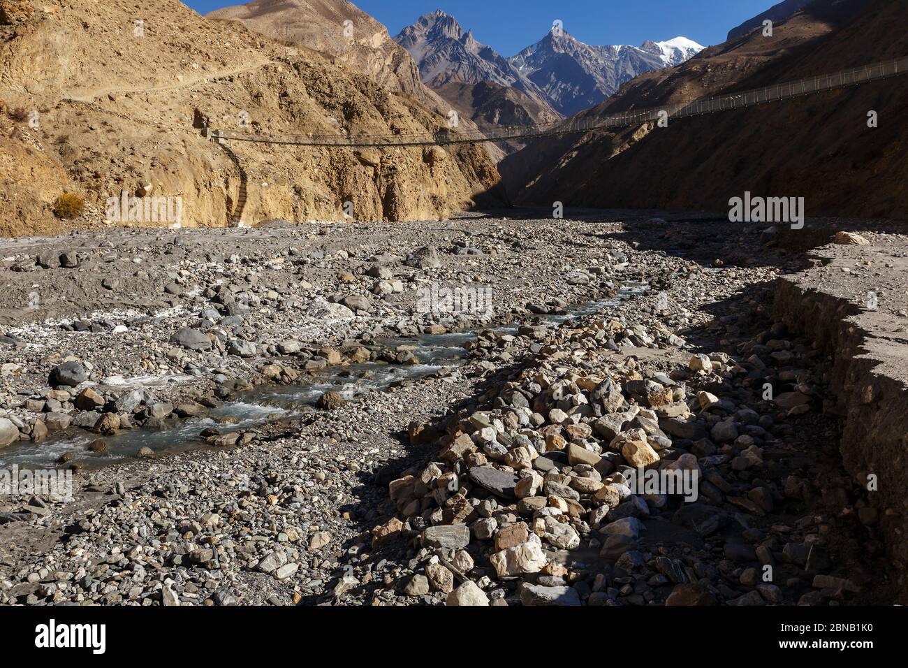 Suspension foot bridge over the gorge in the Himalayas. Nepal Stock ...