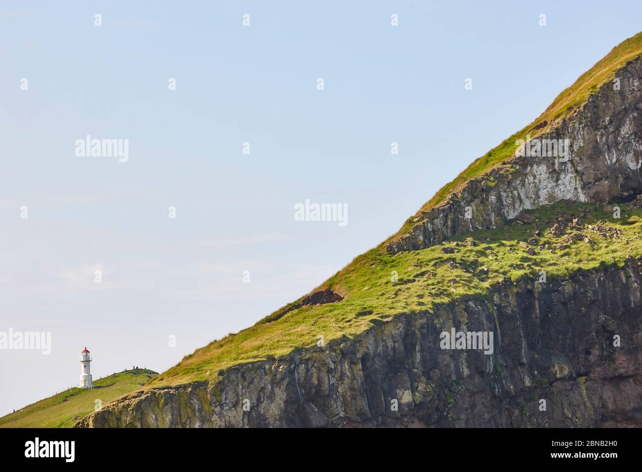 Mykines lighthouse and cliffs on Faroe islands. Hiking landmark ...