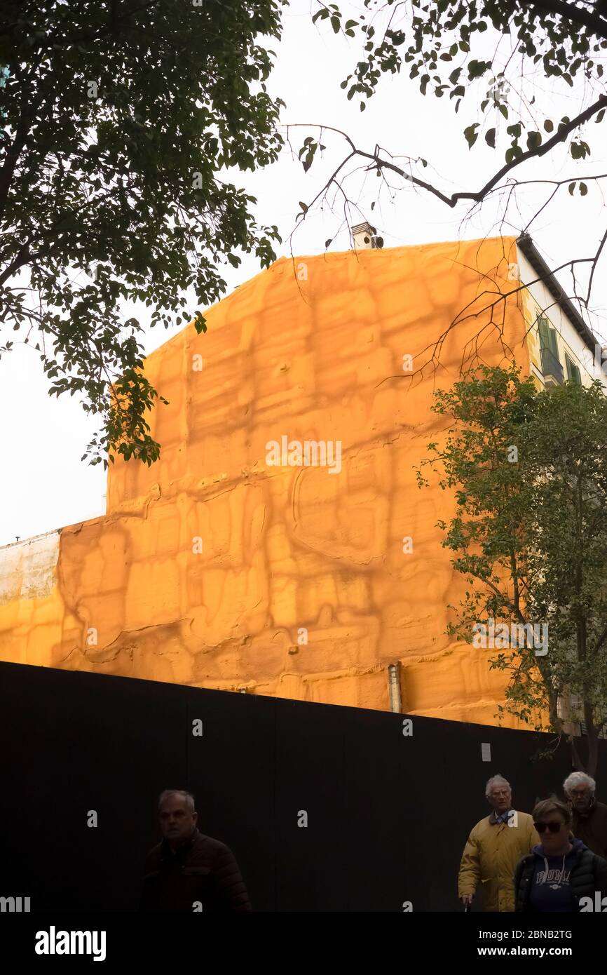 Yellow waterproofing spray along the side of a building with exposed ...
