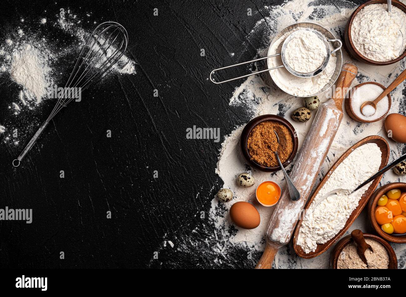 Baking ingredients on black background with copy space Stock Photo - Alamy