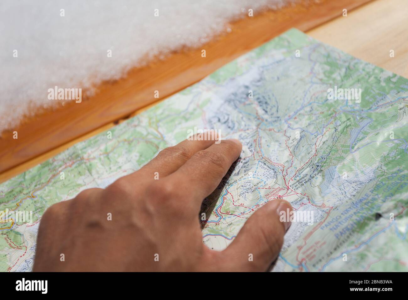 a trekker checking a map during his trip Stock Photo - Alamy