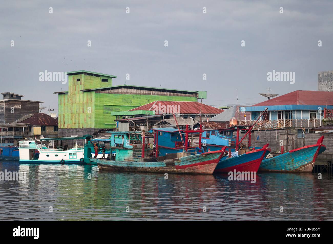 Horizontal view of traditional wooden fishing boats moored in Kumai ...