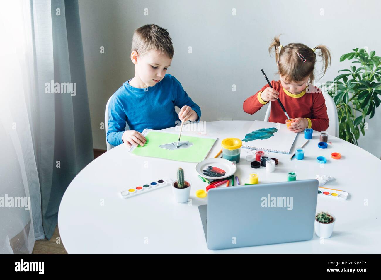 Children, young boy and girl, spending a time drawing using online ...