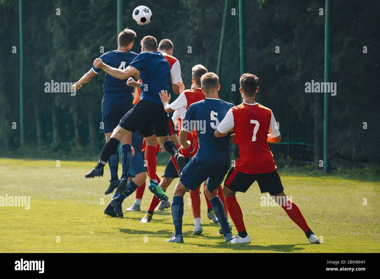 Soccer players heading the ball in competition. Football adult game ...