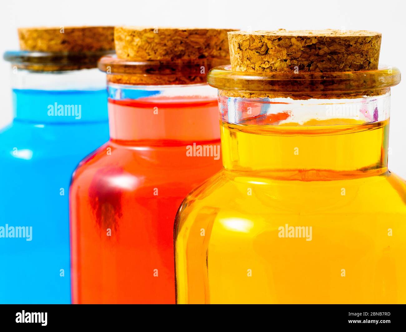 Coloured bottles in white background Stock Photo - Alamy