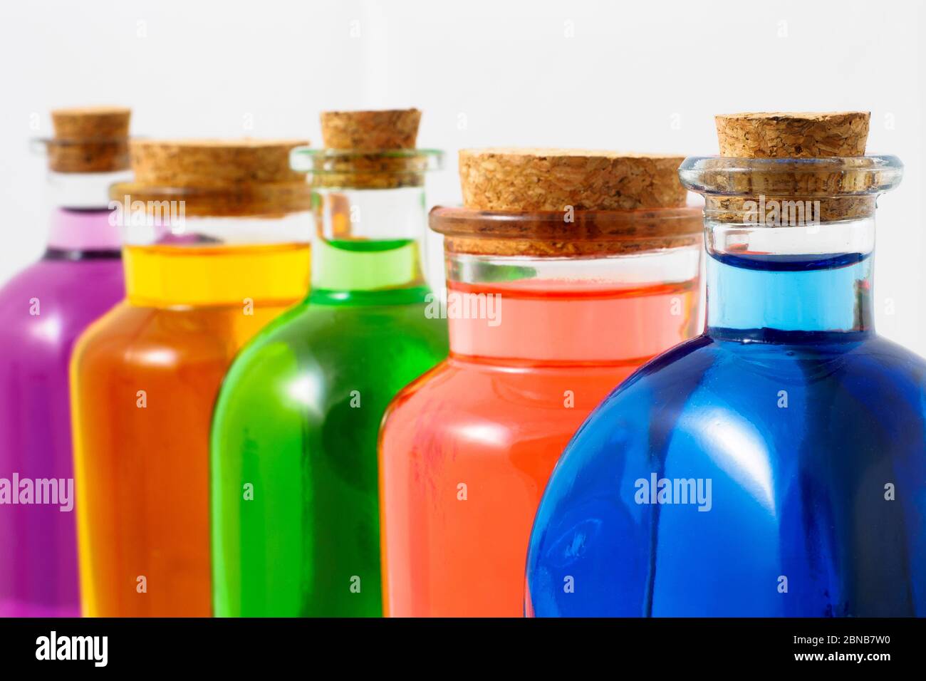 Coloured bottles in white background Stock Photo - Alamy
