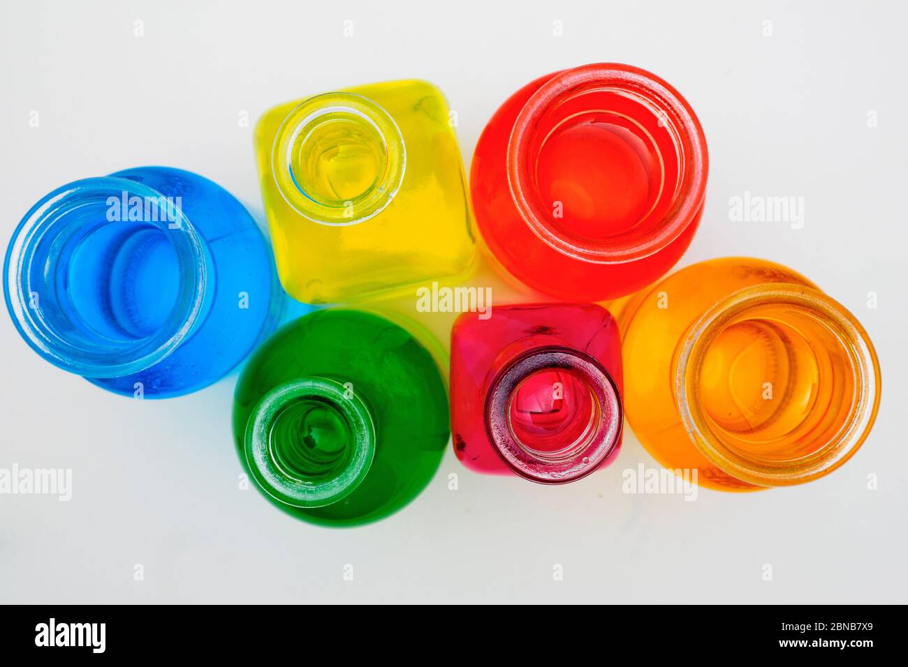 Coloured bottles in white background Stock Photo - Alamy