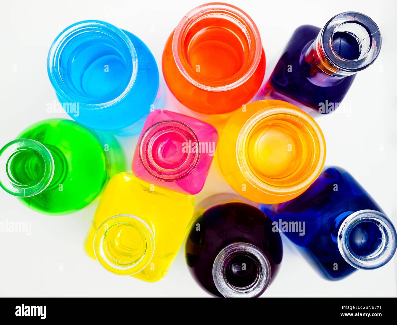 Coloured bottles in white background Stock Photo - Alamy