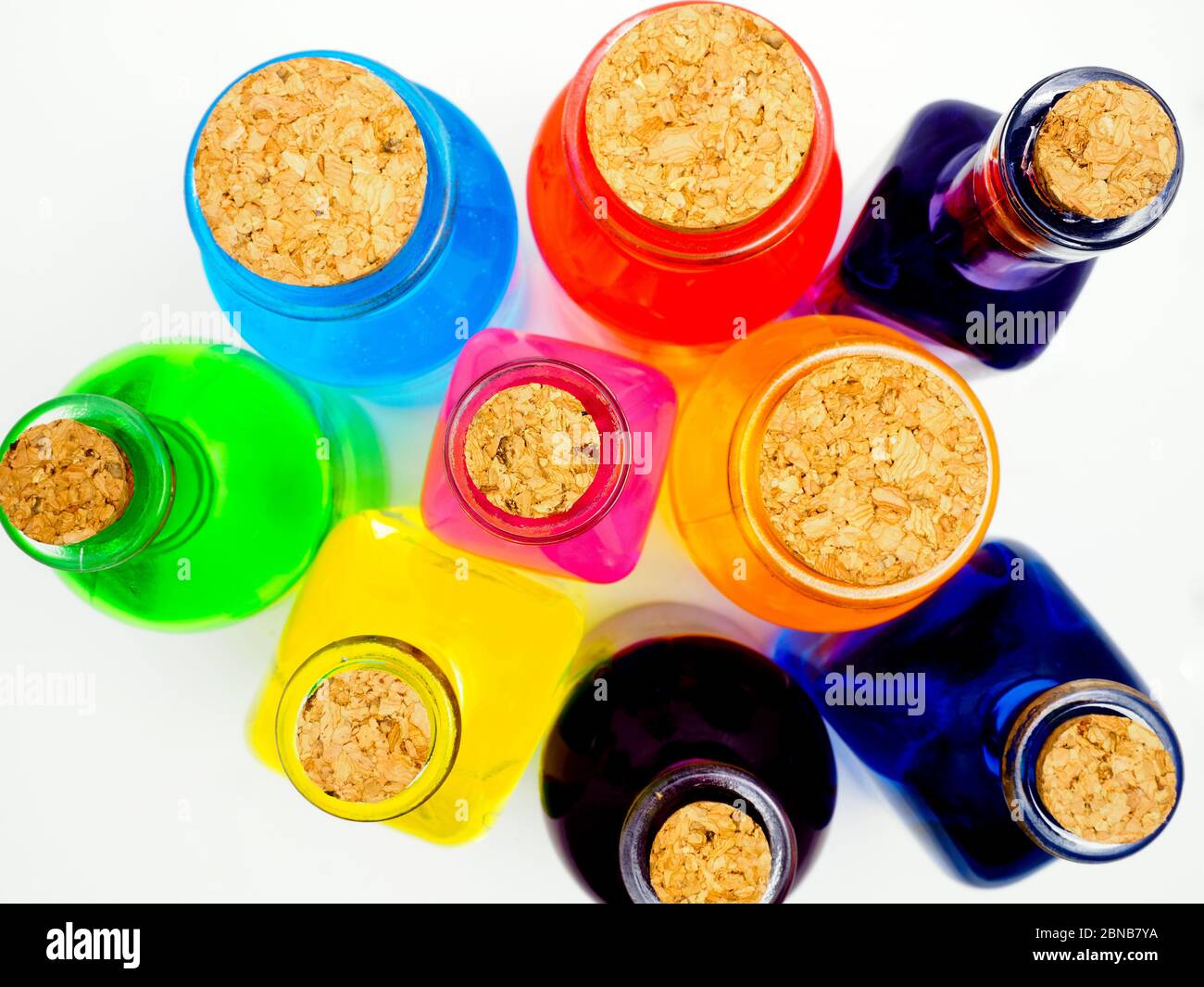 Coloured bottles in white background Stock Photo - Alamy