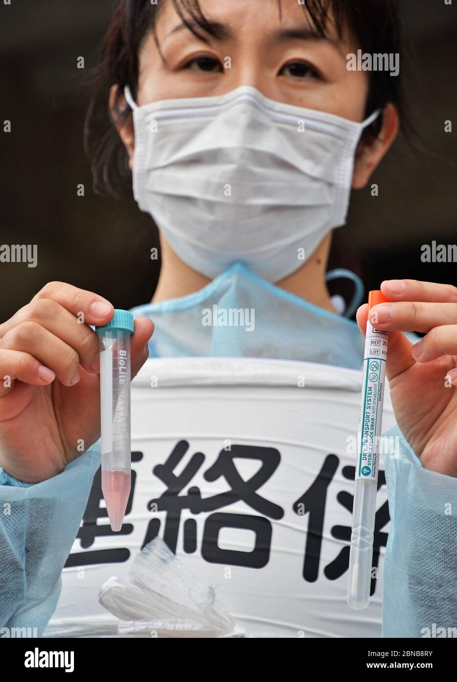 A medical worker show centrifuge tube and flock swab for collect sample ...