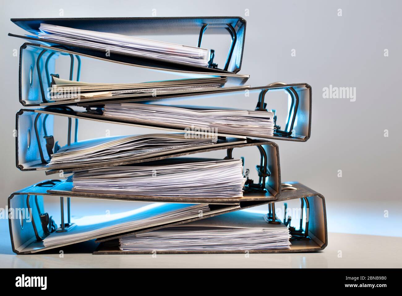 Stack of office folders with archived paperwork in red light Stock ...
