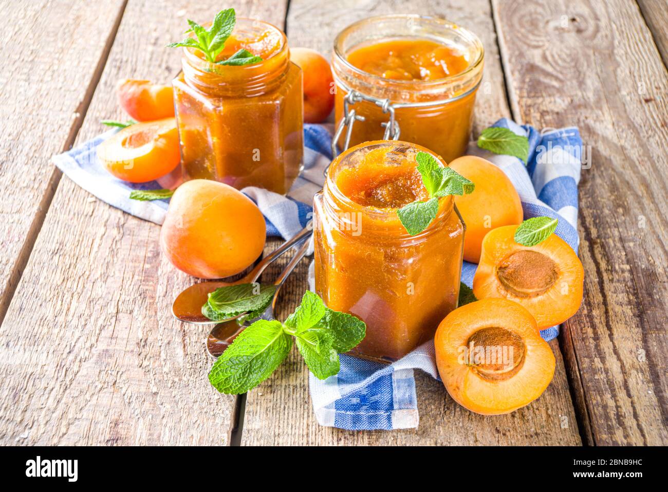 Homemade apricot jam in different jars, with fresh organic apricots on ...
