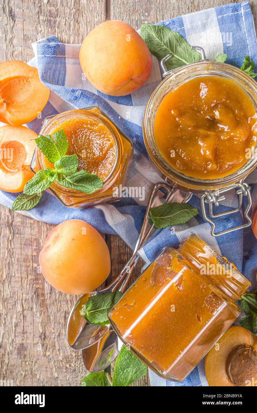 Homemade apricot jam in different jars, with fresh organic apricots on ...
