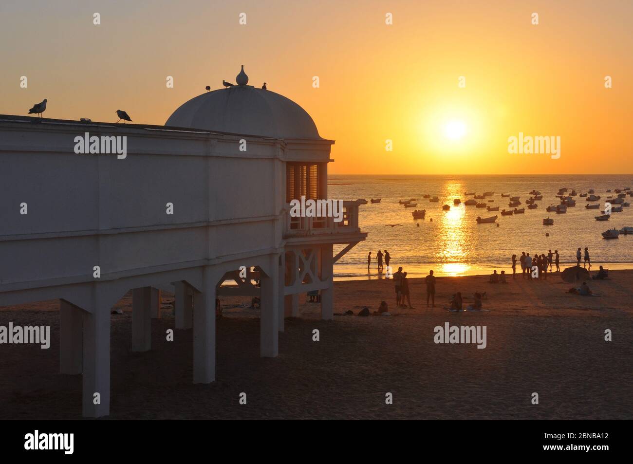 Mesmerizing view of the sunset in La Caleta beach in Spain Stock Photo ...