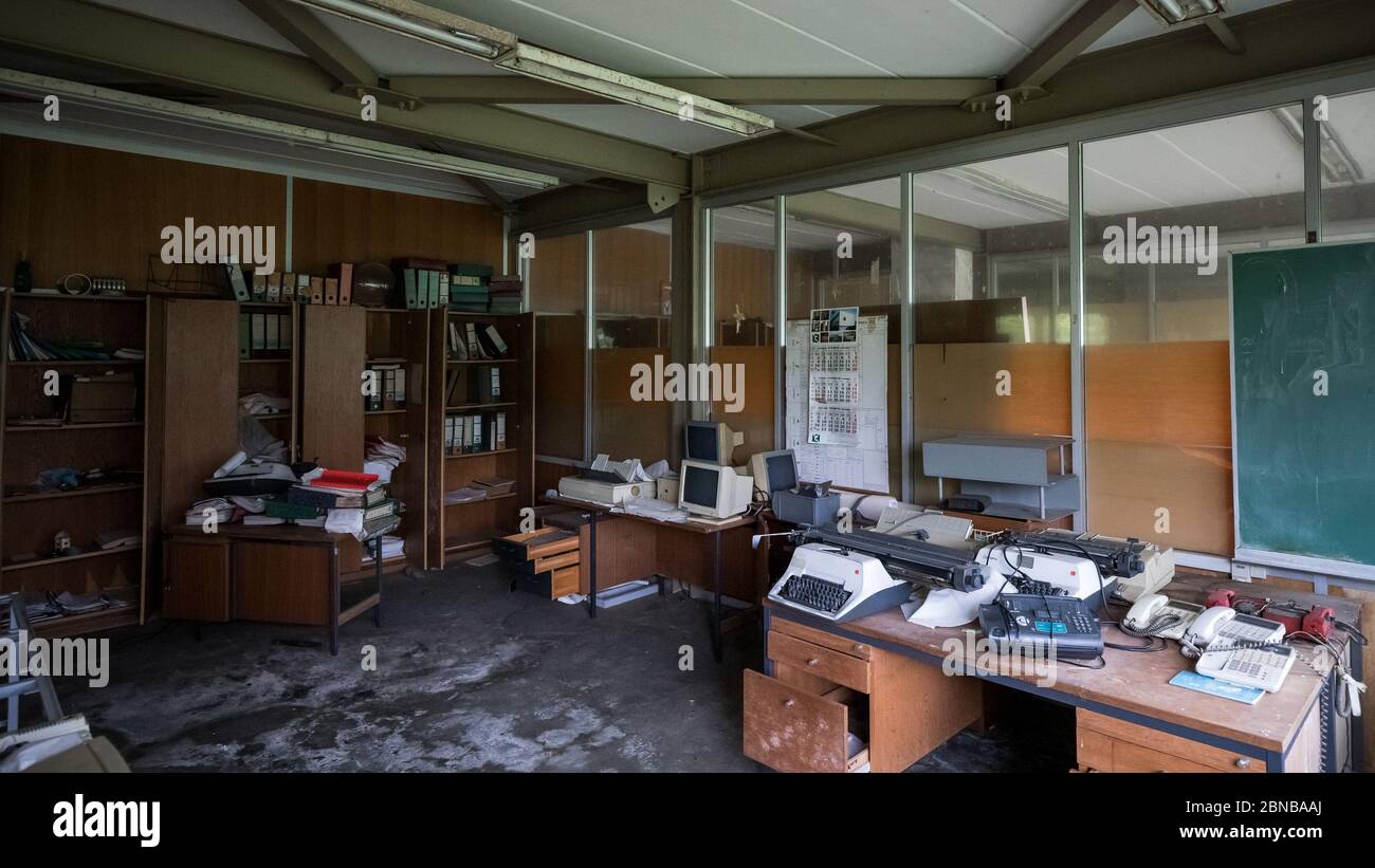 Messy office in an abandoned building Stock Photo - Alamy