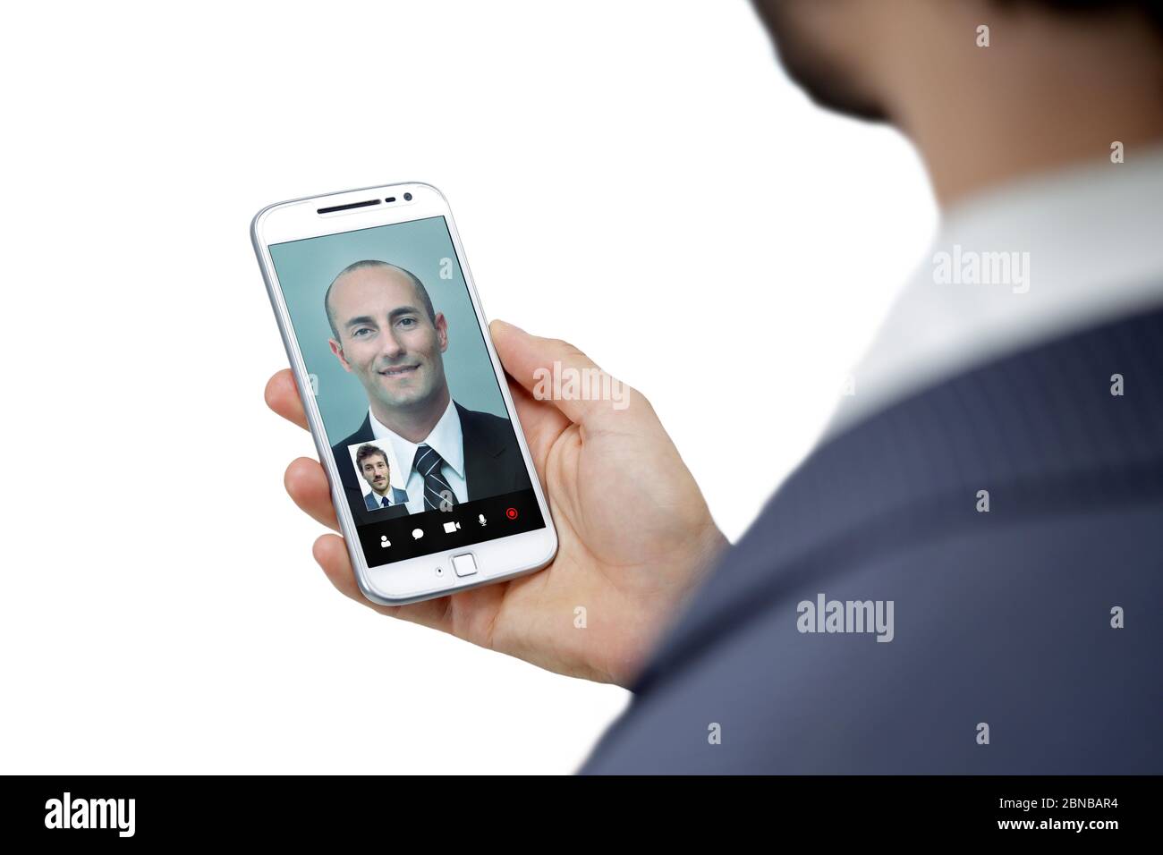 Businessman getting a video call with another man in his mobile phone ...