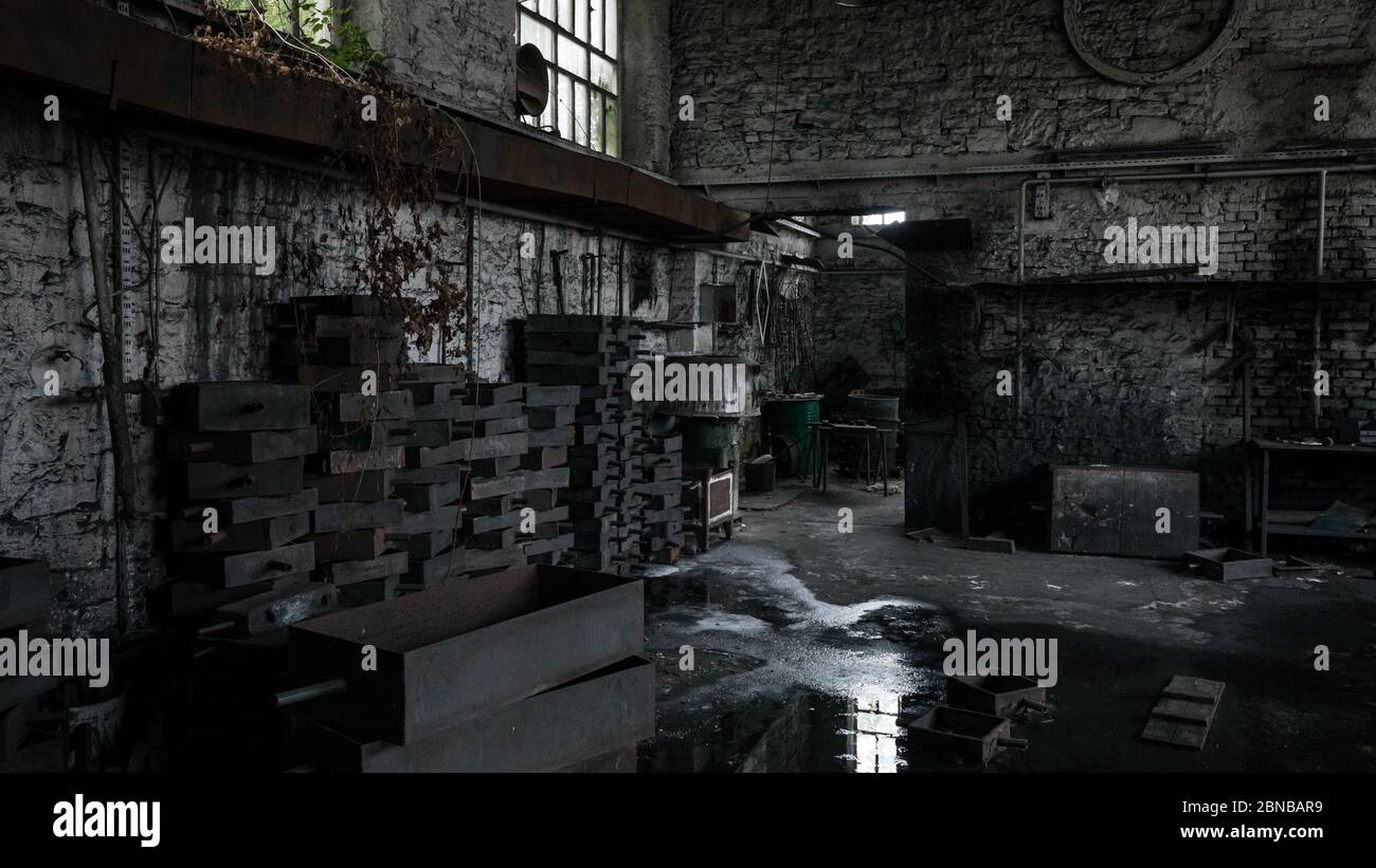 Messy building with stacks of metals and a concrete brick wall Stock ...