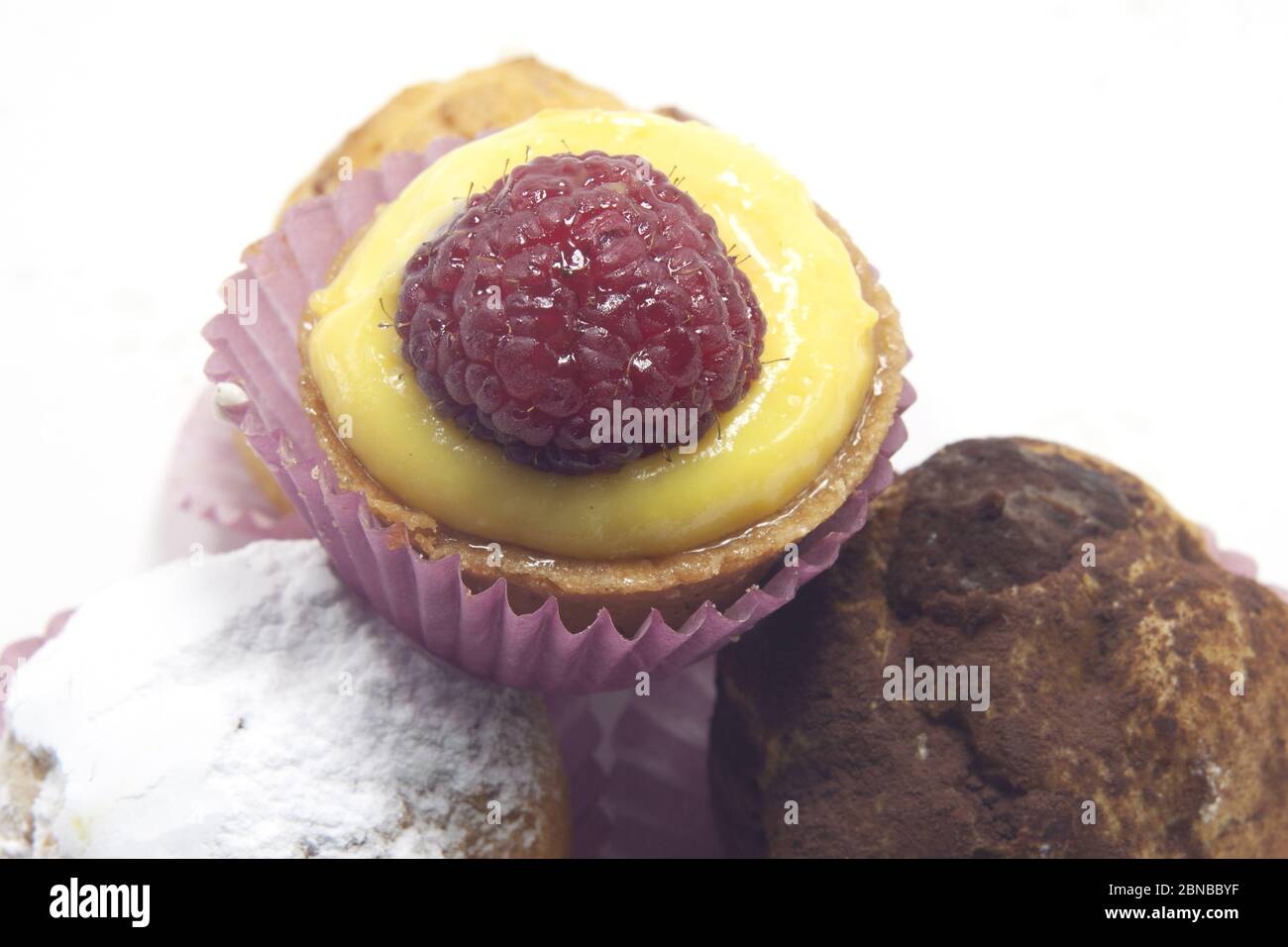 Closeup shot of small pastries topped with different flavors of toppings Stock Photo - Alamy