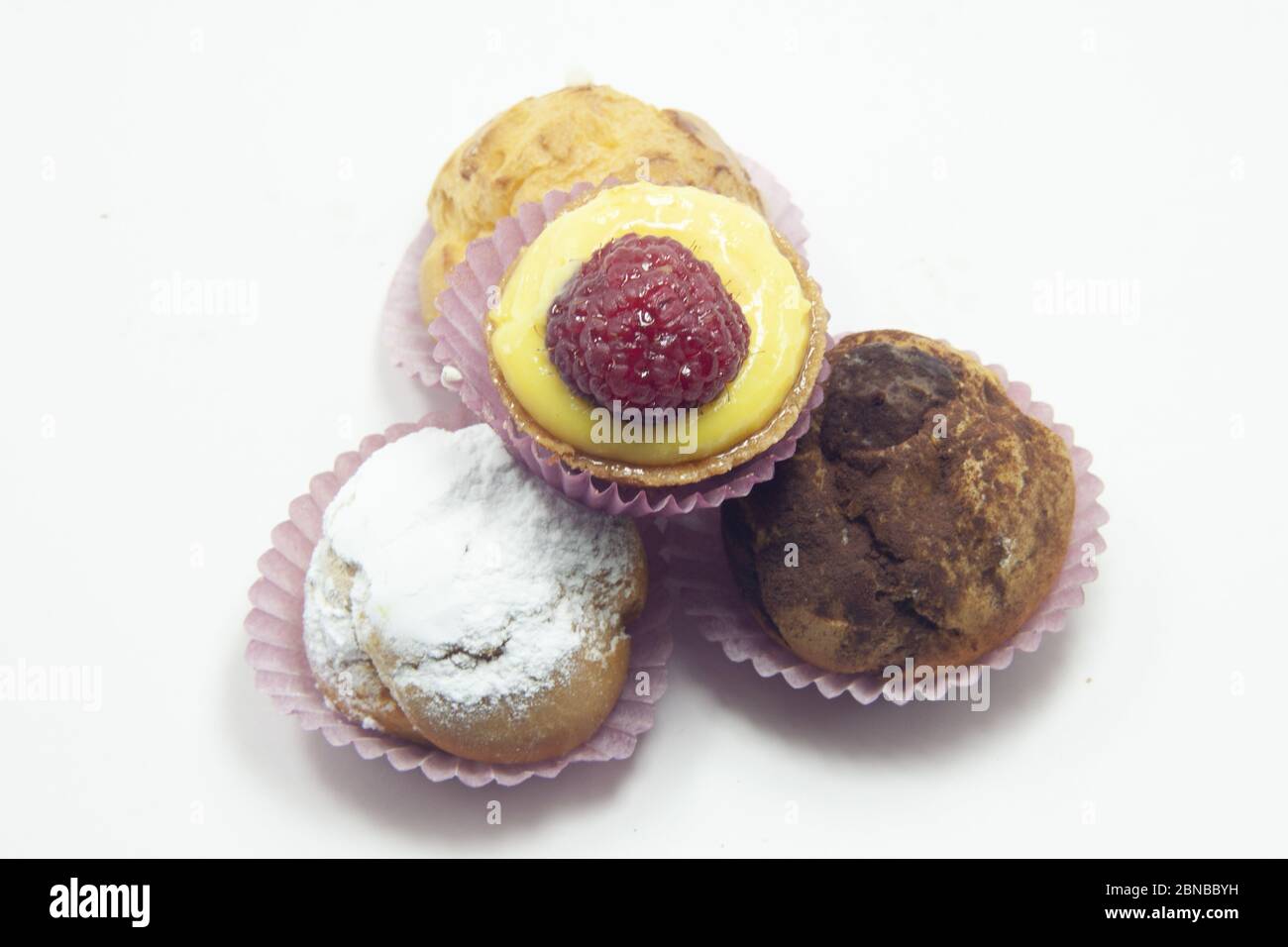 Closeup shot of small pastries topped with different flavors of toppings Stock Photo - Alamy