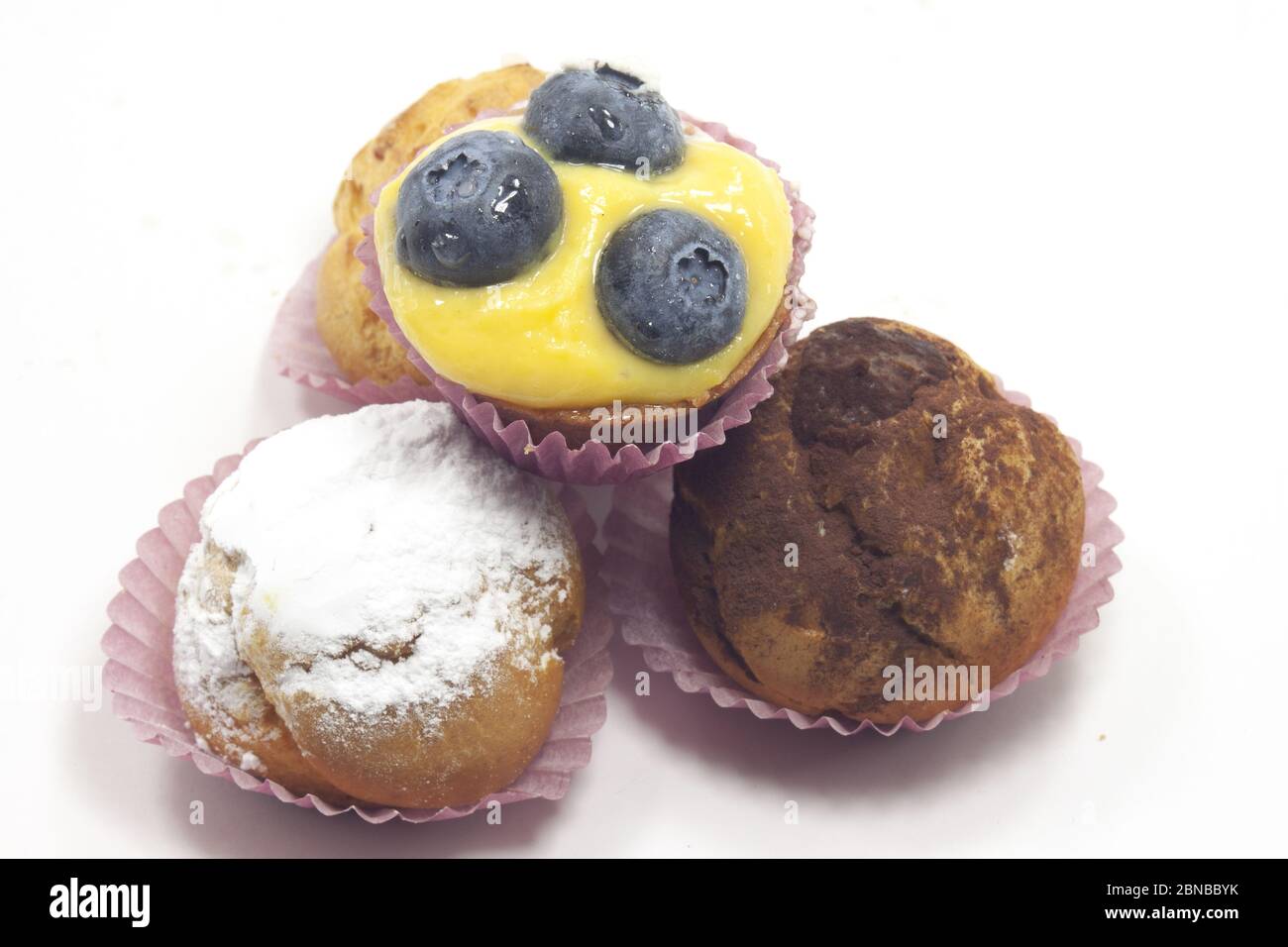 Closeup shot of small pastries topped with different flavors of ...
