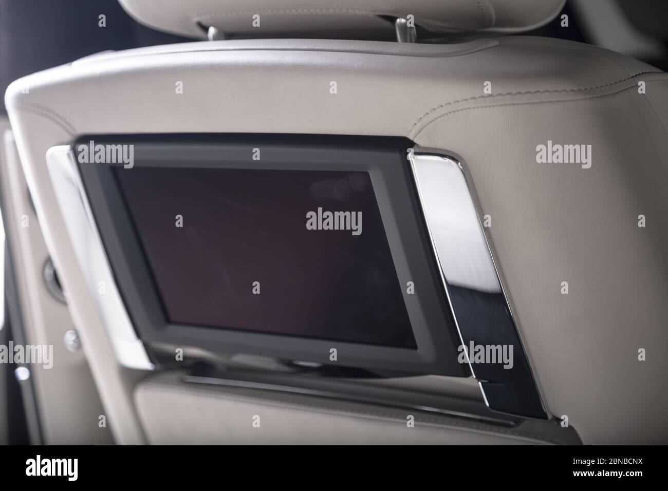 Clsoeup shot of a screen on the back of the seat in the modern car ...
