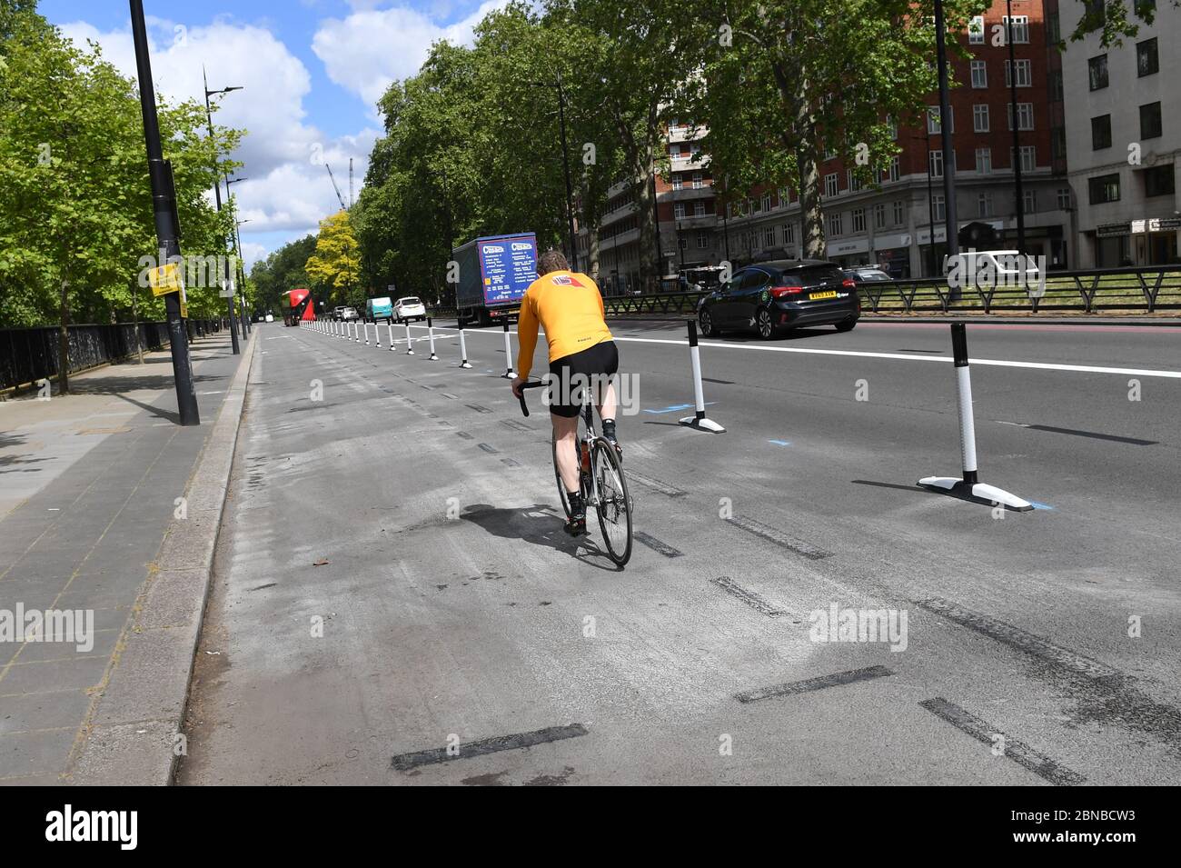 A man rides a bicycle in a pop-up cycle lane in Park Lane, London ...