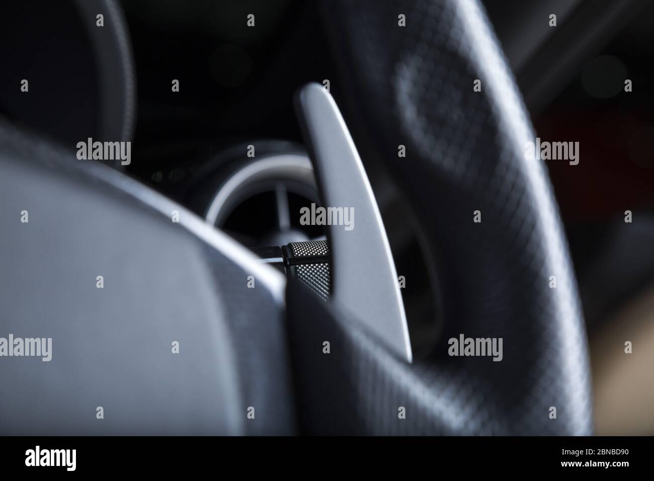 Closeup shot of the turn signal button on the steering wheel of a ...