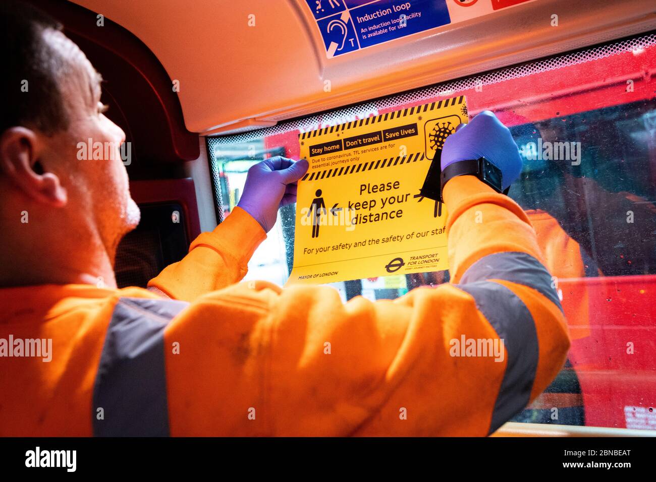 Stickers are installed on a routemaster bus to remind passengers to ...