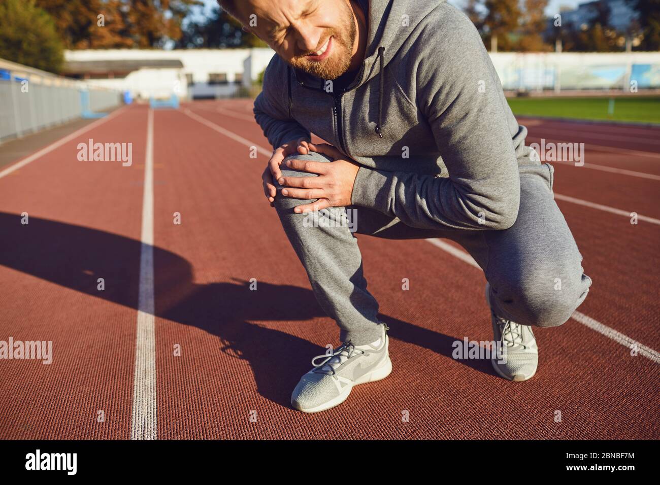 Knee injury in training. Man injured his leg during exercise. Injury ...