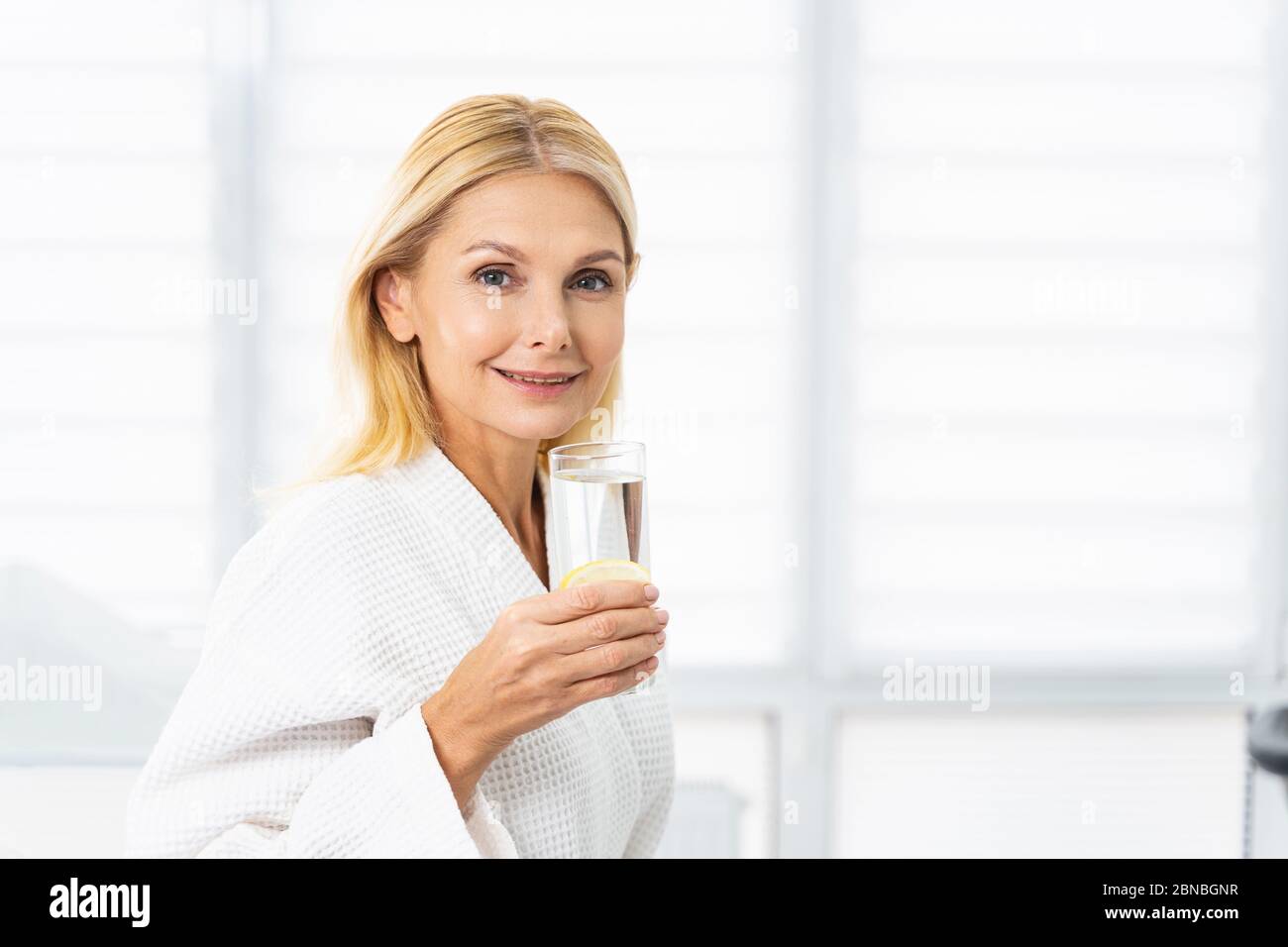 Happy female patient with a healthy drink Stock Photo - Alamy