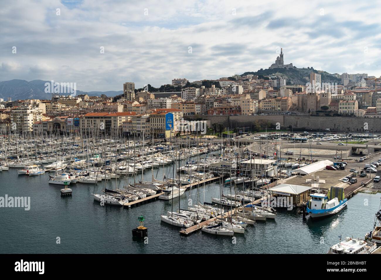 Aerial shot of the beautiful Marseille old port and the and Notre Dame ...