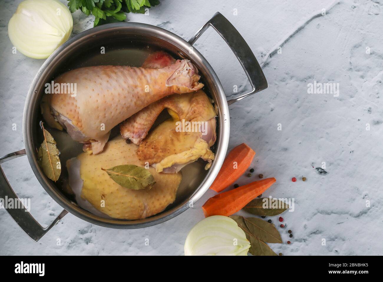 Cooking broth from homemade chicken with pepper and bay leaf in a pan ...