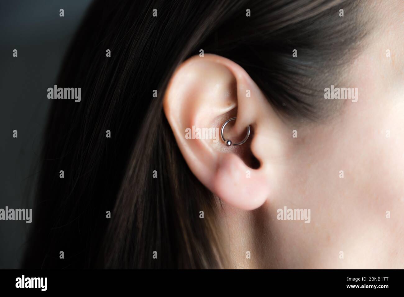 Ear piercing woman hi-res stock photography and images - Alamy