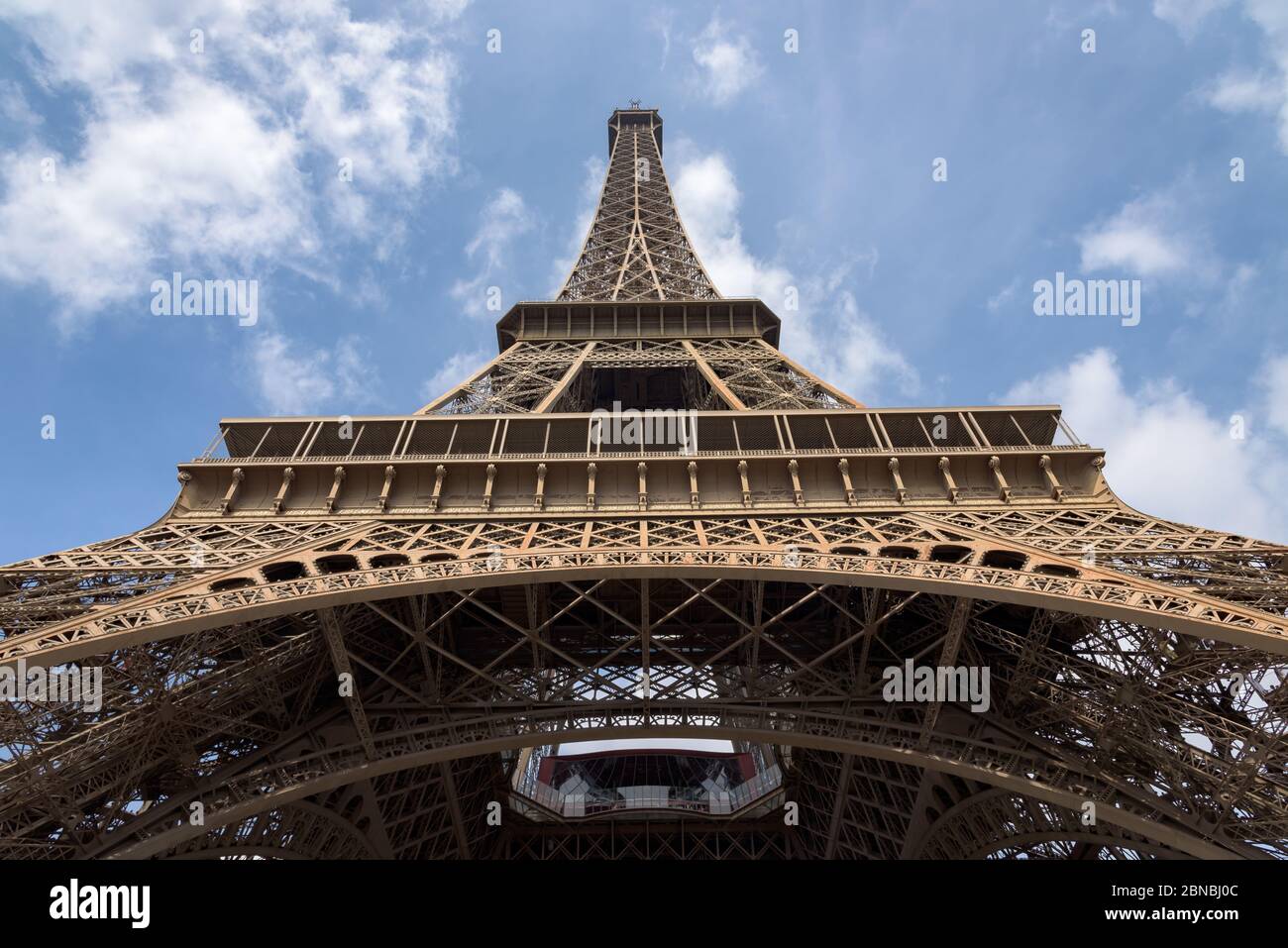 View of the Eiffel tower on a sunny summer day in Paris. It is the ...