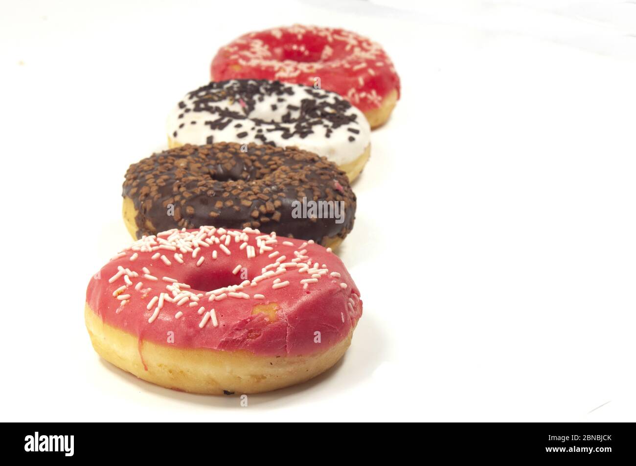 Closeup of American glazed doughnuts under the lights isolated on a ...