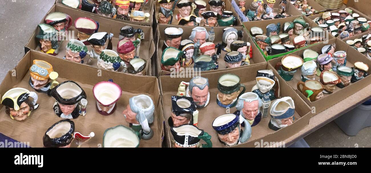 Panoramic shot of boxes of cute mugs made like famous people's faces ...