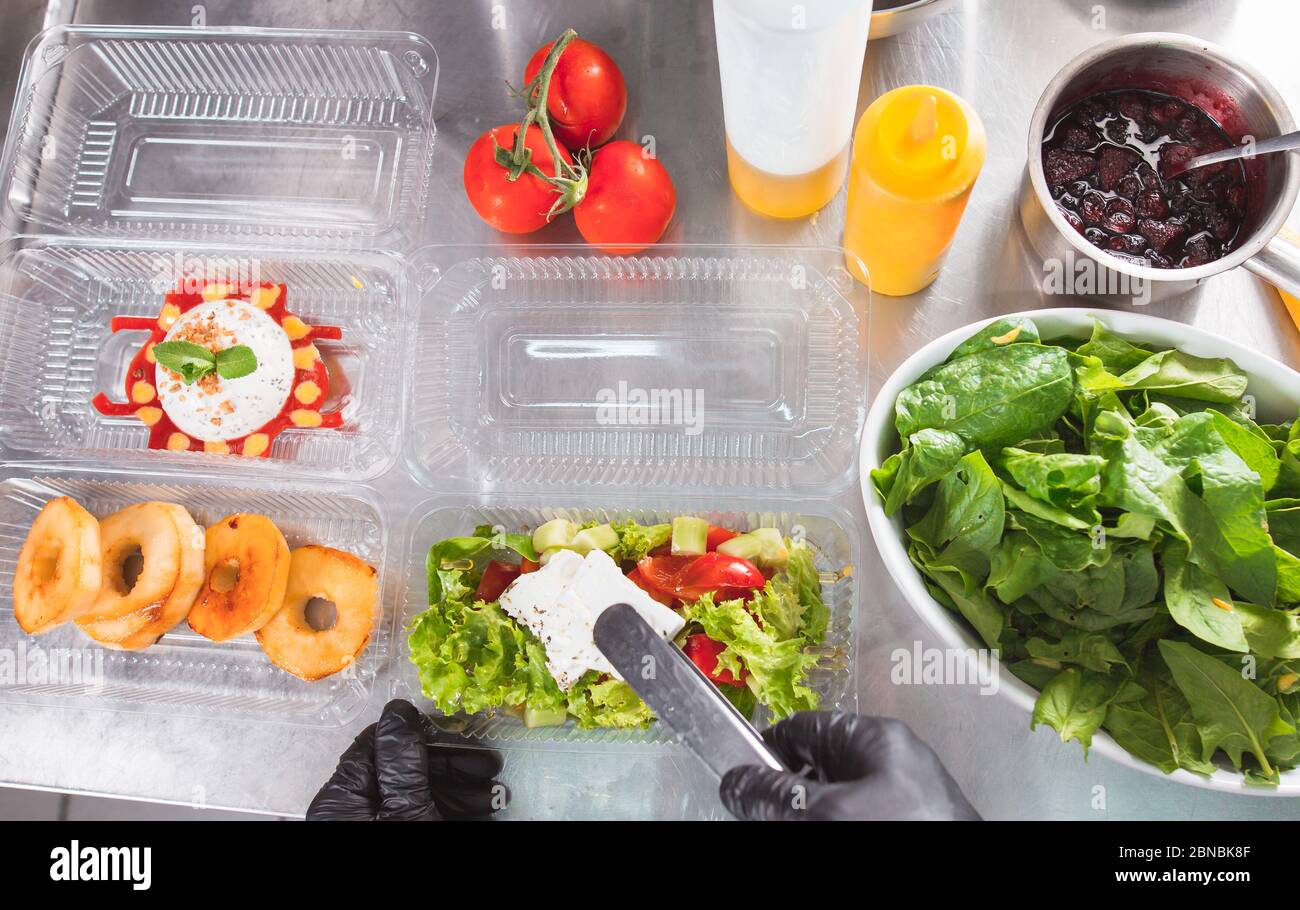 cooking in a restaurant and packing in a container for delivery Stock ...