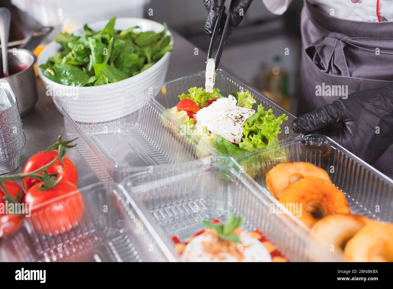 cooking in a restaurant and packing in a container for delivery Stock ...