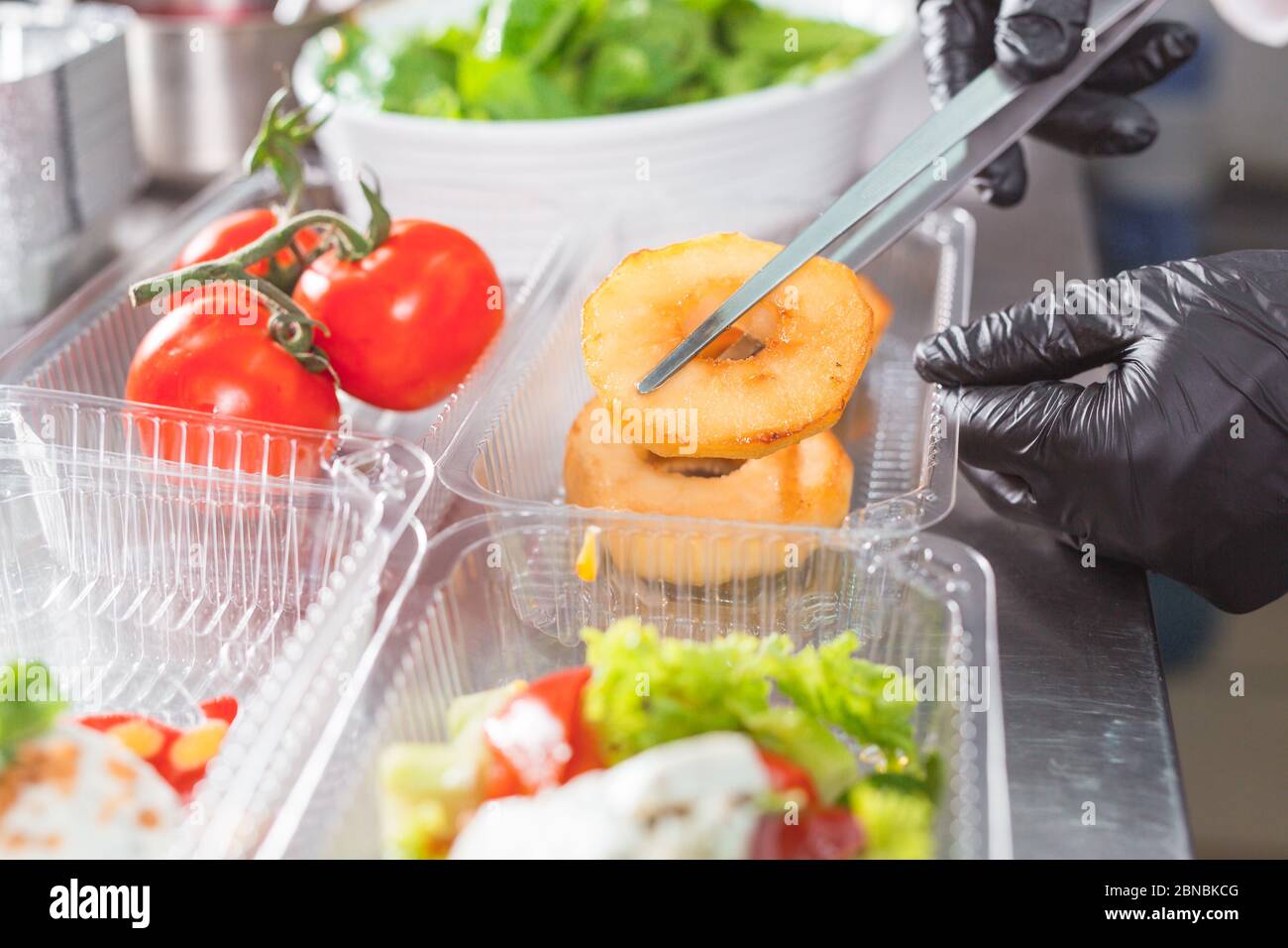 cooking in a restaurant and packing in a container for delivery Stock ...